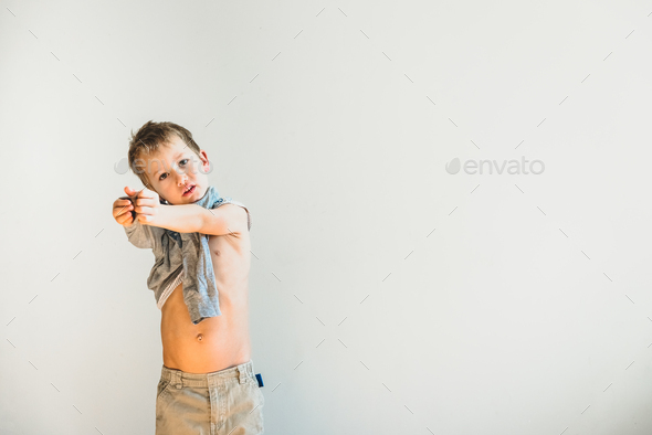 Child undressing before going to sleep, alone, learning to be ...