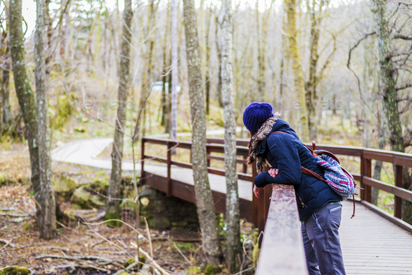 girl with backpack standing near old footbridge Stock Photo by raferto1973