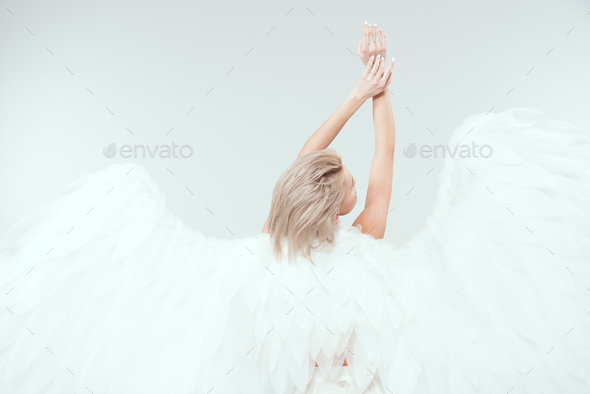 back view of woman with angel wings posing isolated on white with copy ...
