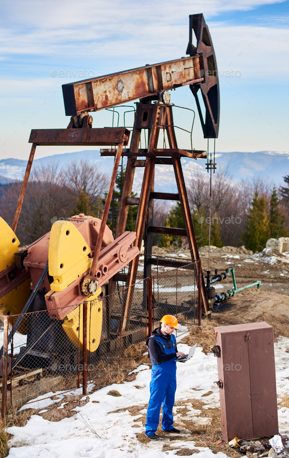 Oil man working in oil field with petroleum pump jack. Stock Photo by ...