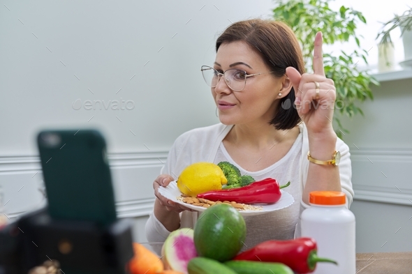 Woman recording video stream about healthy eating, vitamins ...