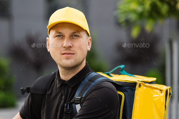 Delivery man yellow in cap and thermo bag or backpack riding a electric ...