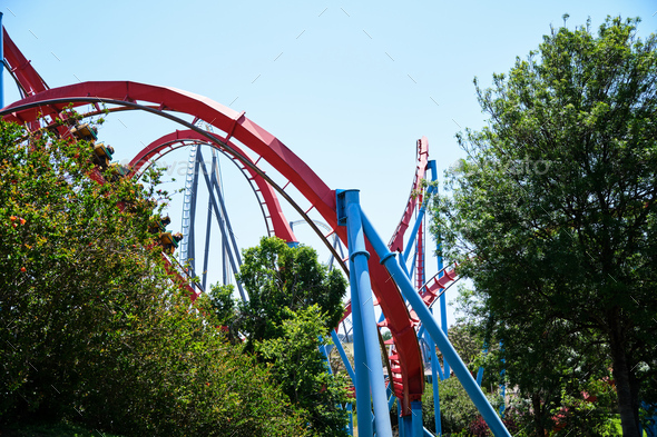 Inverted roller coaster with narrow metal rails, an ideal summer day to ...