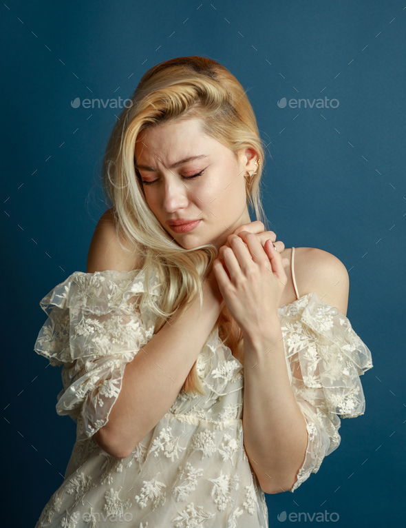 Sad girl holding her hands together and crying Stock Photo by 13people