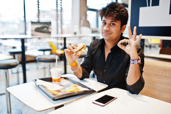 Indian man at fast food cafe Stock Photo by ASphotostudio | PhotoDune