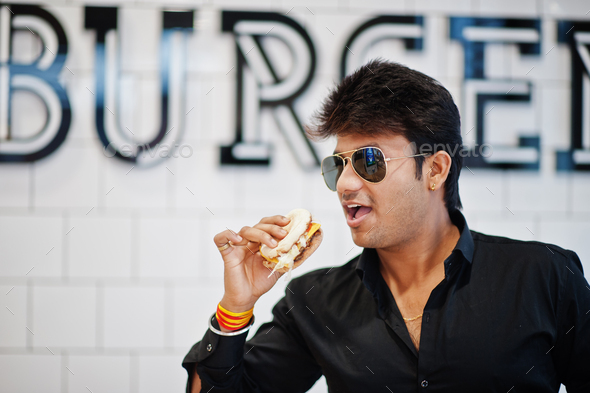 Indian man at fast food cafe Stock Photo by ASphotostudio | PhotoDune