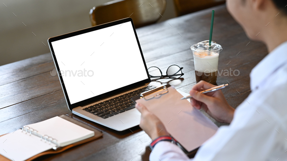 View over businessman shoulder using computer laptop while sitting in ...