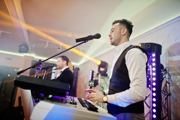 Musicial music live band performing on a stage with different lights ...