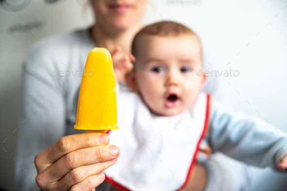 Baby smiling and drooling when trying for the first time an ice cream ...