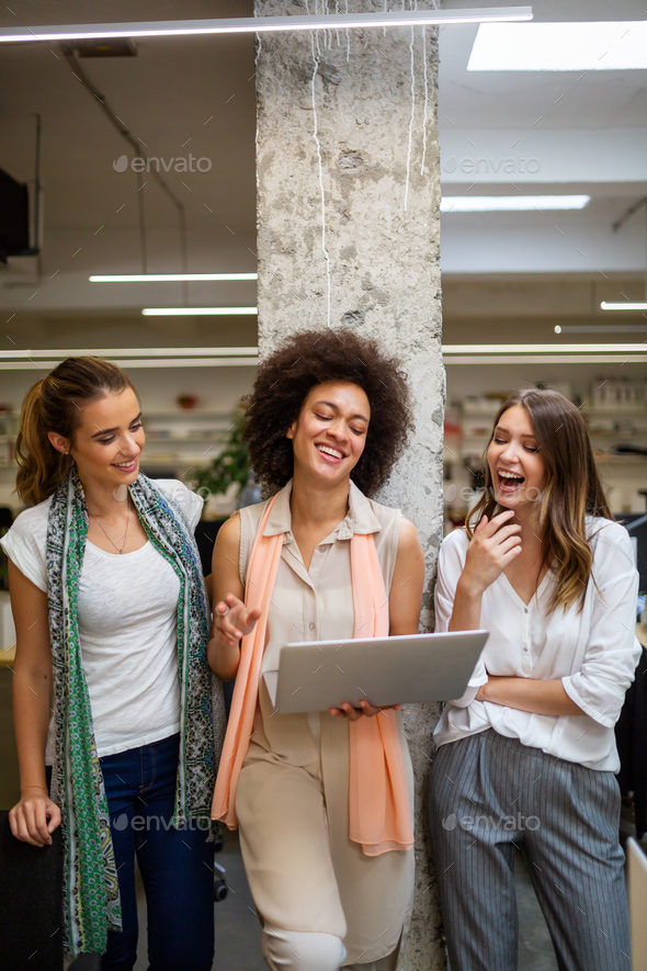 Portrait of happy business women working as a team at the office on ...
