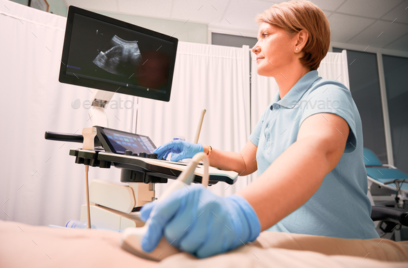 Doctor performing ultrasound procedure in modern clinic. Stock Photo by ...