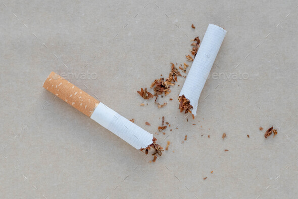 Crushed cigarette and tobacco on a neutral background. Smoking ...