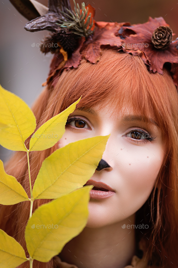 fairy woman with deer horns in autumn forest. Face painting Stock Photo ...