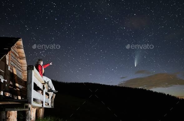 Man looking at stars on sky at night. Stock Photo by anatoliy_gleb