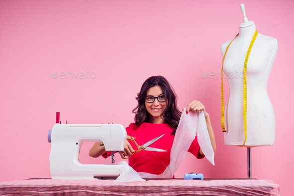 sewing pattern,sewing machine and maniken in studio pink background ...