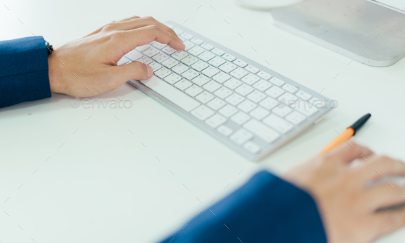 Employee hand typing on computer keyboard working at desk Stock Photo ...