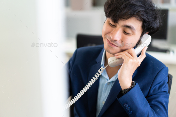 Male financial advisor talking on the phone with customer Stock Photo ...
