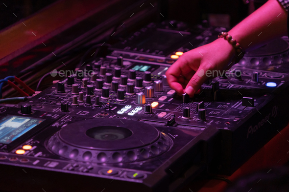 Mixes on CD players or track at nightclub during party for DJ ...