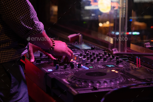 Mixes on CD players or track at nightclub during party for DJ ...