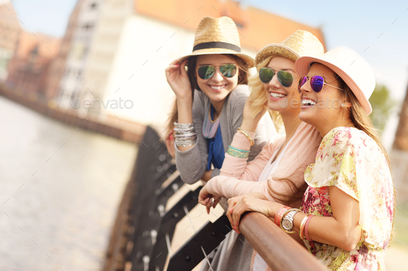 Three friends hanging out in the city Stock Photo by macniak | PhotoDune