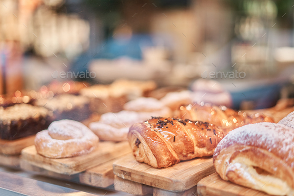 Sweets and croissants displayed in a pastry shop window. Selective ...