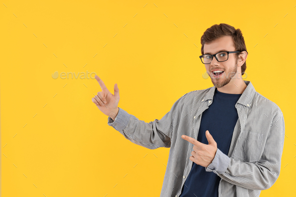 Concept of people, young man on yellow background Stock Photo by ...