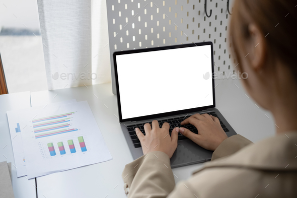 View over shoulder young businesswoman using laptop computer at her ...