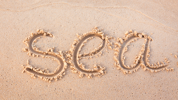 word "sea" written on beach sand Stock Photo by nzooo | PhotoDune