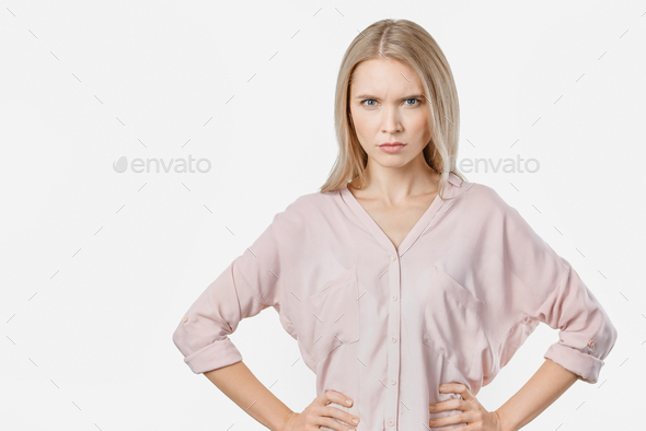 Angry young woman standing isolated over white background Stock Photo ...