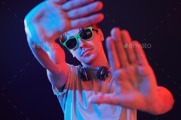 Dj is having fun. Man standing in the studio with neon light Stock ...