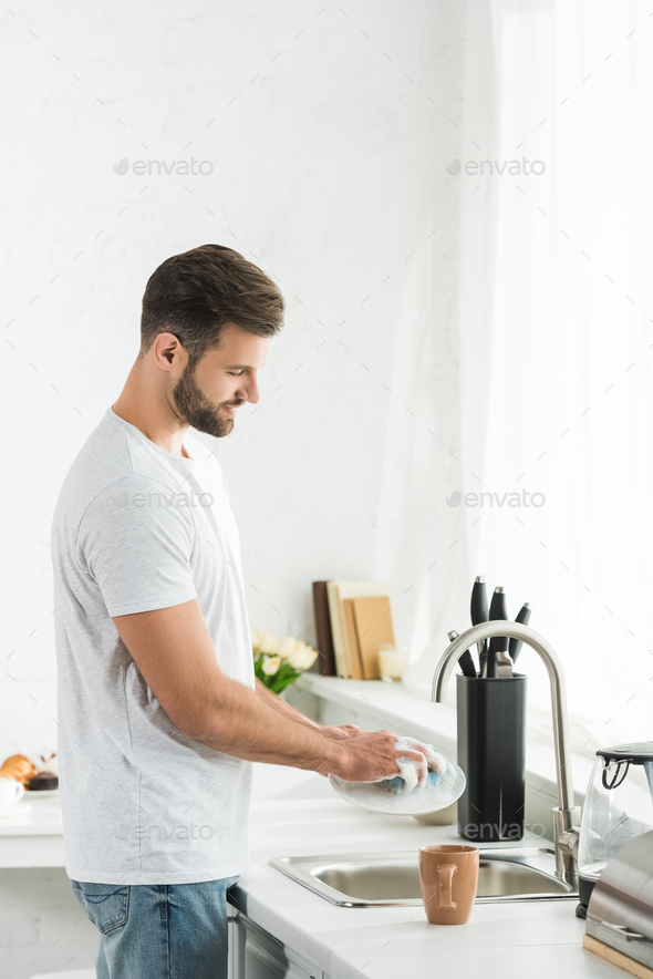 handsome man washing dishes at kitchen in morning Stock Photo by ...