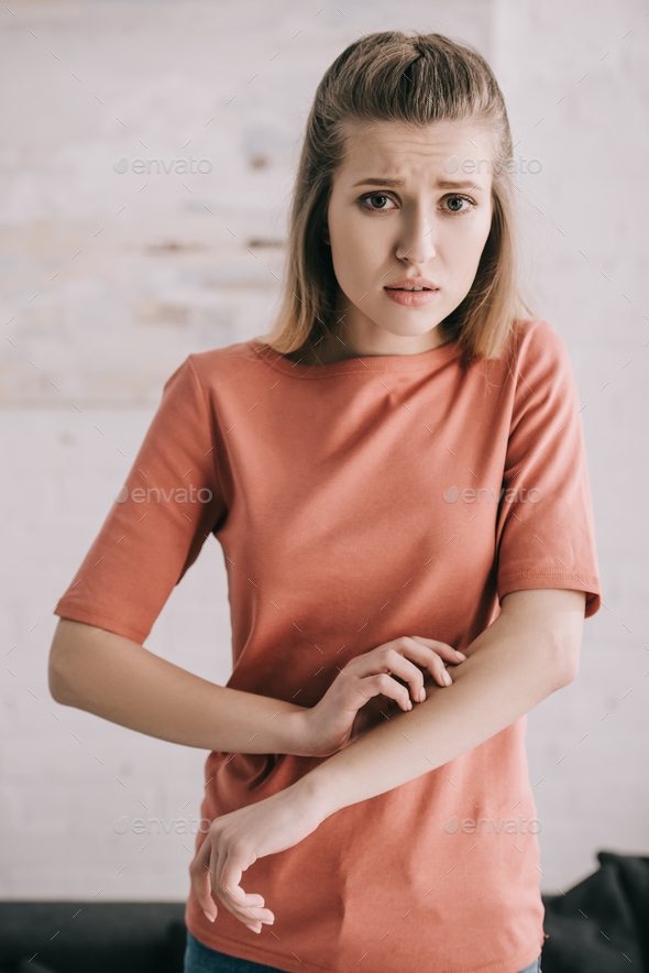 sad blonde woman scratching hand while having allergy Stock Photo by ...