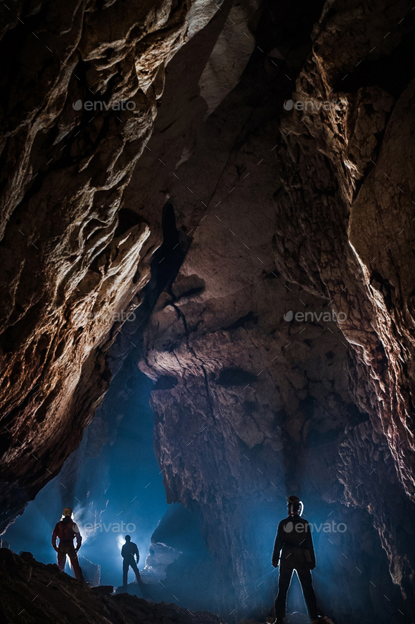 Spelunkers exploring underground a gigantic cave chamber Stock Photo by ...
