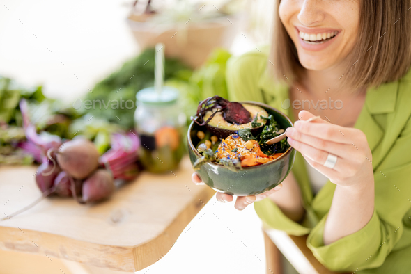 Relaxed woman with healthy food in the room with plants Stock Photo by ...