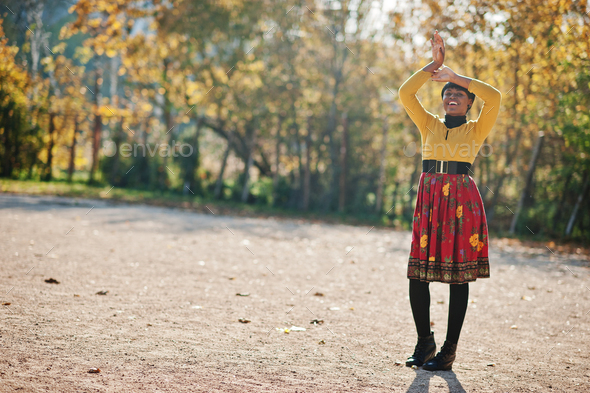African american girl at yellow and red dress at golden autumn fall ...