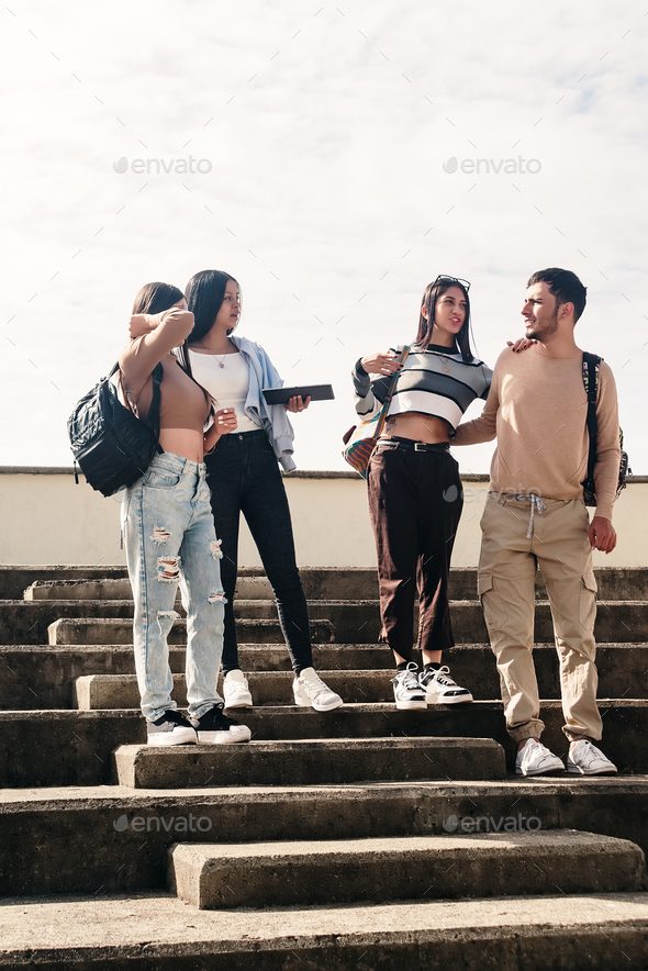 University classmates sharing ideas and smiles after class. Stock Photo ...