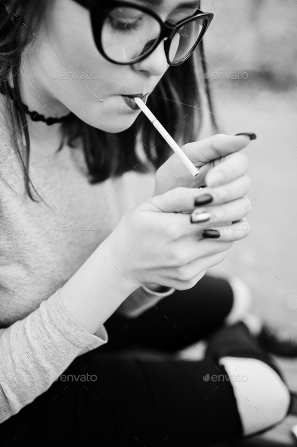 Young girl lighting cigarette outdoors close up. Concept of nicotine ...