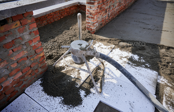 Concrete screed mixer machine at construction site. Stock Photo by ...