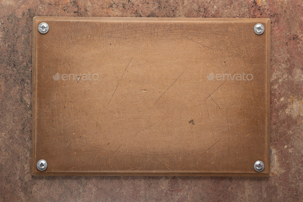 Wooden nameplate or sign board screwed at wall background. Front view ...