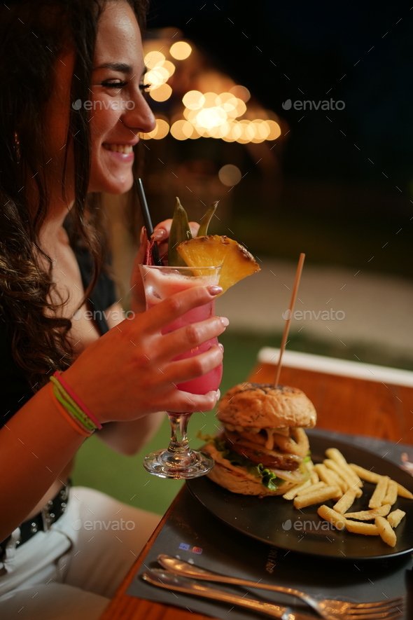 burger pub outdoor table night time cocktail Stock Photo by CCpreset