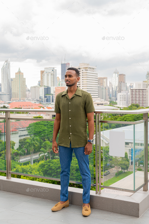 Portrait of handsome young black man outdoors in city Stock Photo by ...