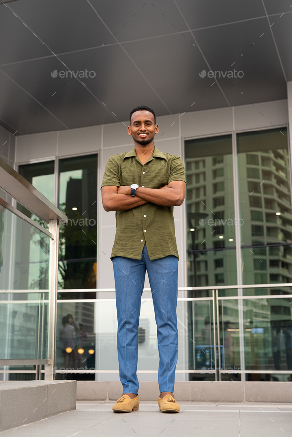Portrait of handsome young black man outdoors in city Stock Photo by ...