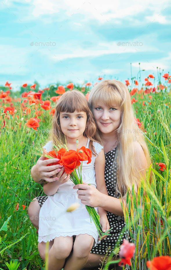 children girl in a field with poppies. selective focus. Stock Photo by ...