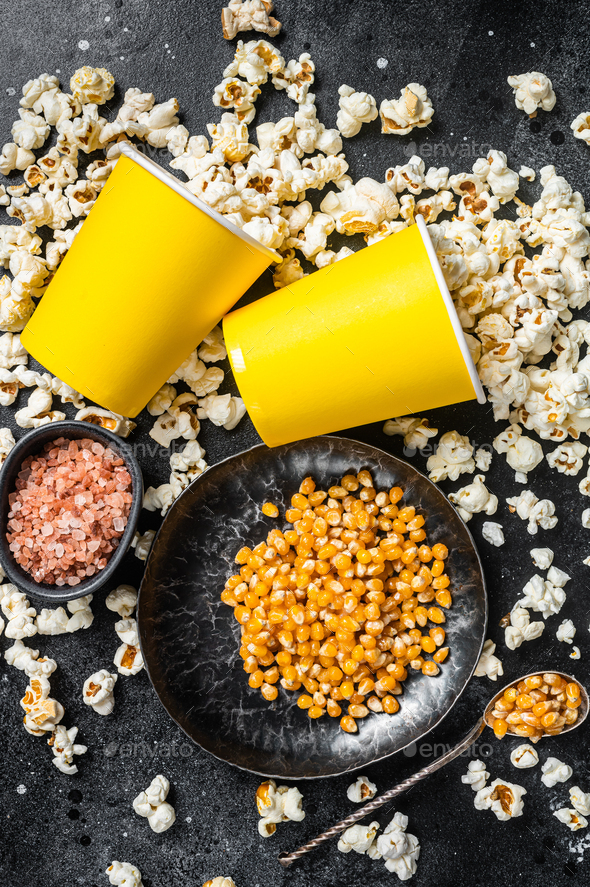 Buttered Salted popcorn with corn kernel and salt. Black background ...