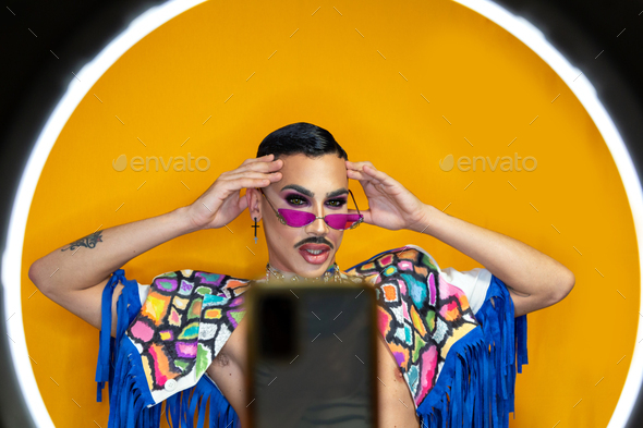 Young non-binary drag queen guy taking a picture of himself with a ...