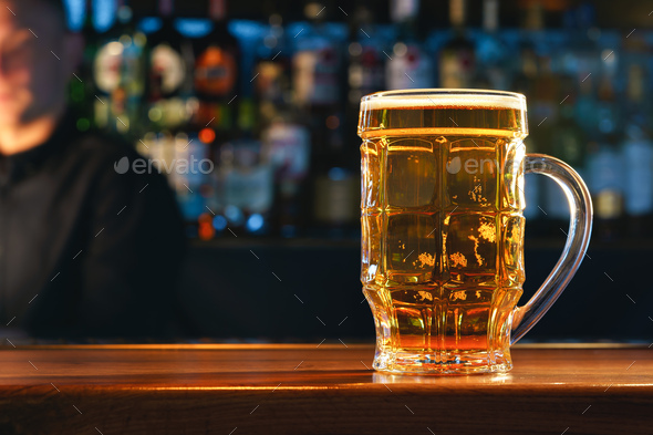 Fresh cold beer in glass on bar background Stock Photo by FabrikaPhoto