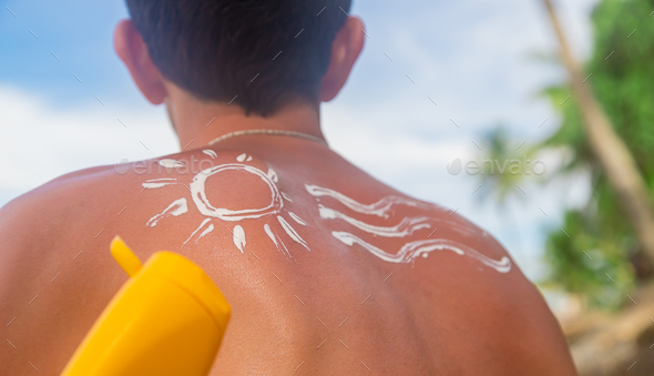 A man on the beach with sunscreen on his back. Selective focus. Stock ...