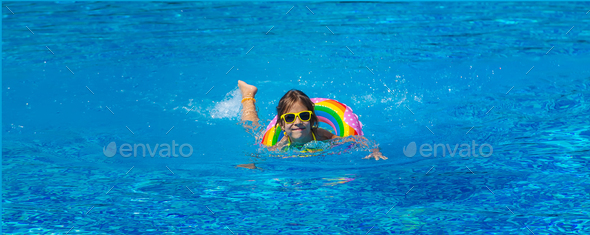 The child swims with a circle in the pool. Selective focus. Stock Photo ...