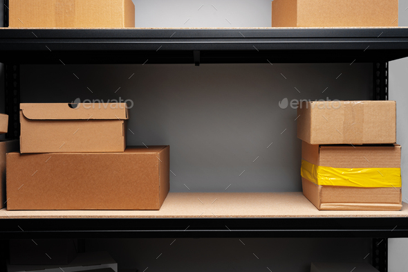 Rack shelves with paper boxes in warehouse. Stock Photo by FabrikaPhoto