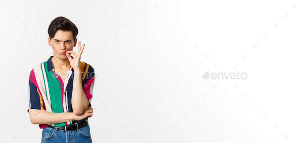 Sulking man zipping mouth, seal lips with promise, looking serious ...